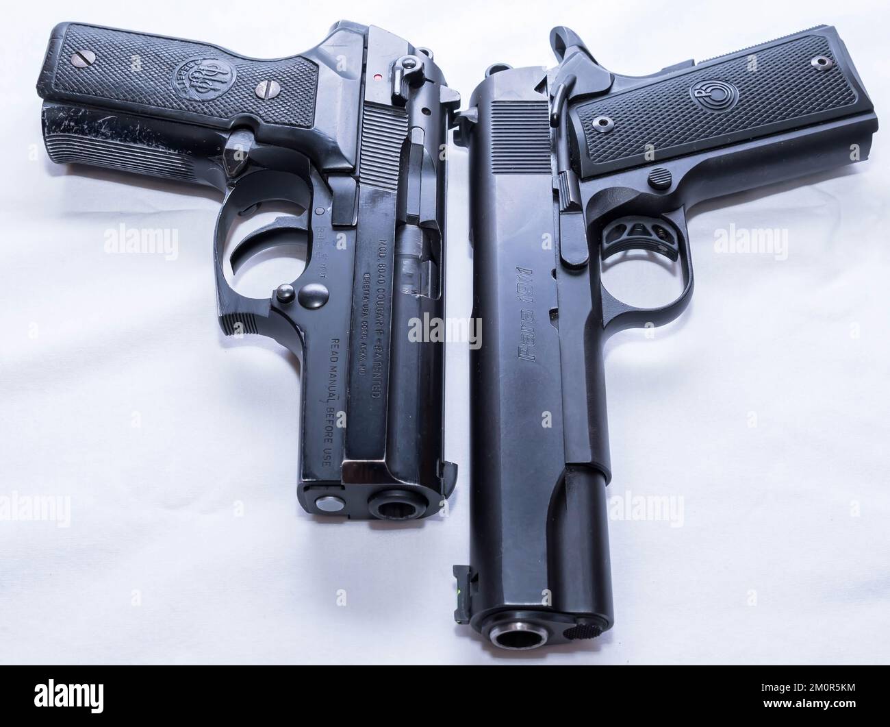 Two pistols, a 40 caliber Berreta and a longer 45 caliber 1911 Para ...
