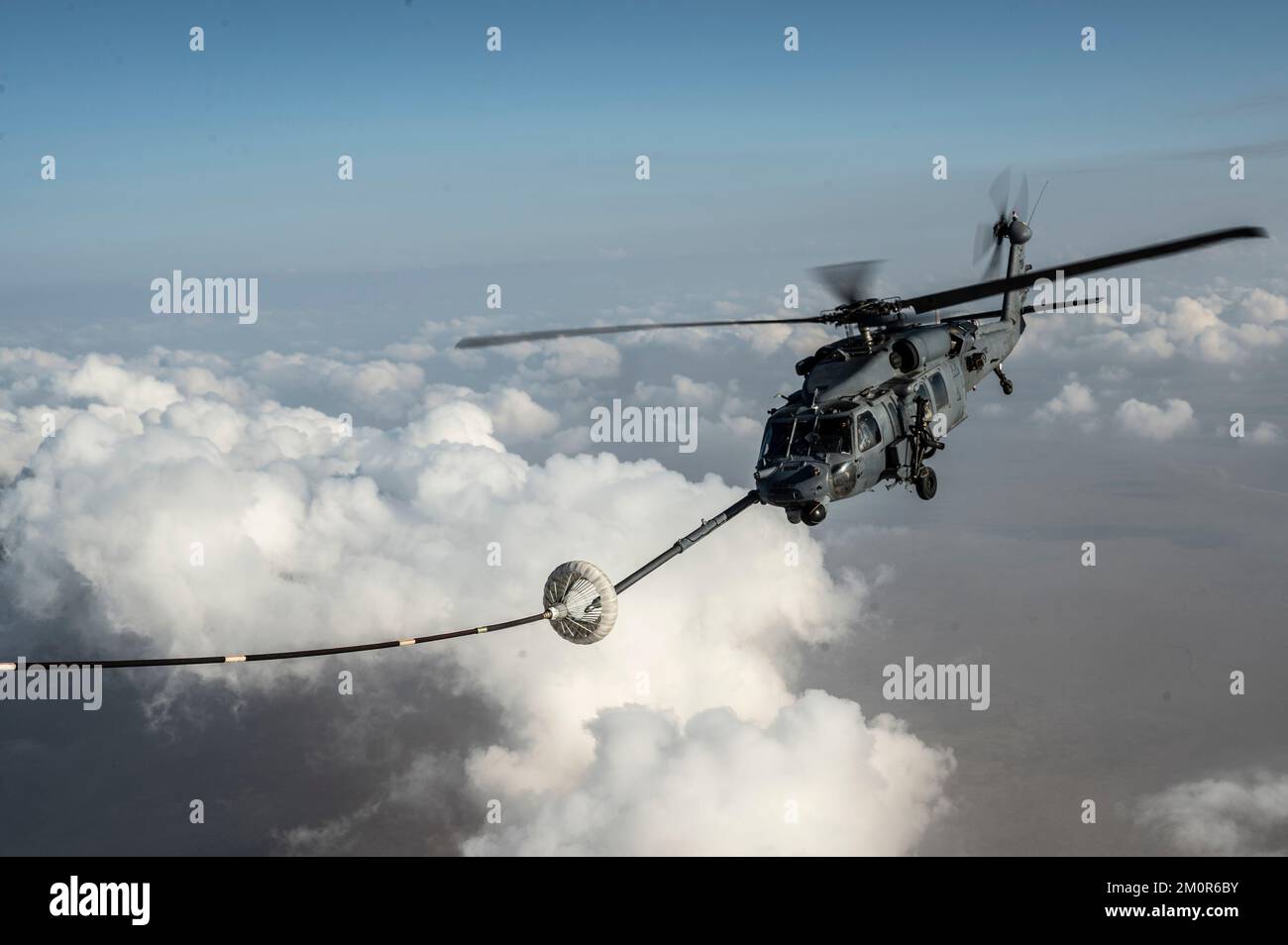 A U.S. Air Force HH-60G Pave Hawk helicopter and an HC-130J Combat King ...
