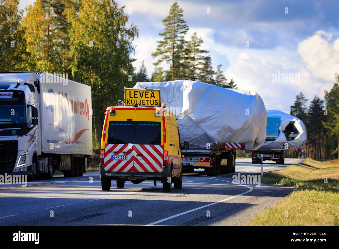 Truck gives way as two oversize load transports assisted by pilot and ...