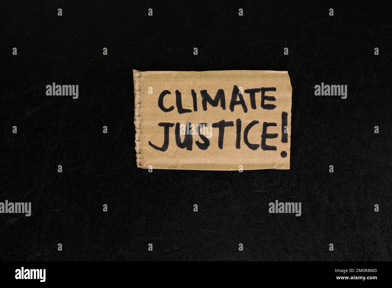 Climate justice concept. Carton placard with handwritten message in ...