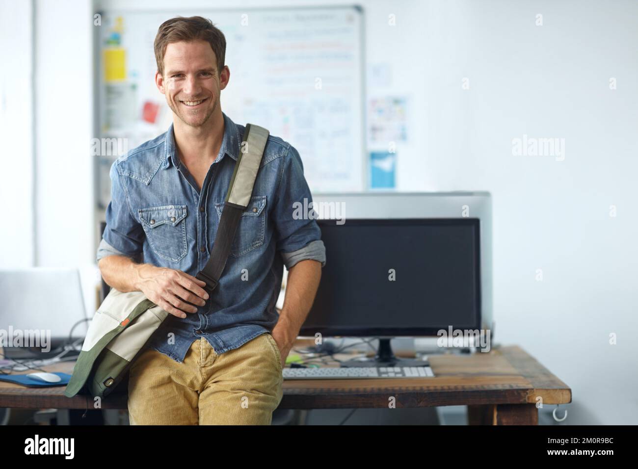Professional man leaning against desk hi-res stock photography and ...