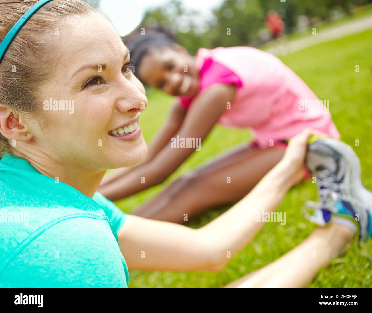 Happy stretching. Close up cropped shot of a female runner cooling down ...