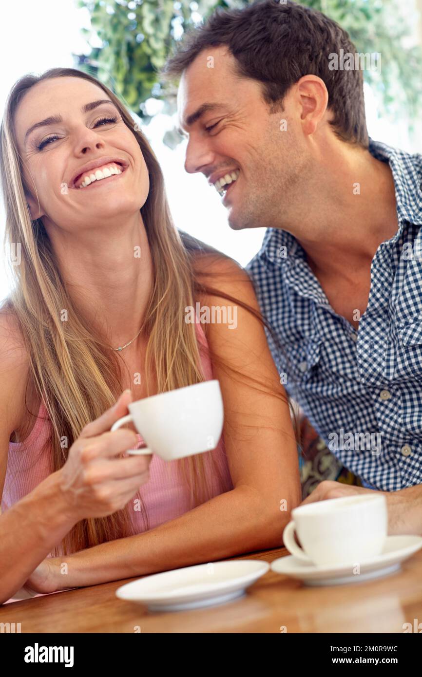 Coffee happiness. An attractive young couple enjoying a cup of coffee ...