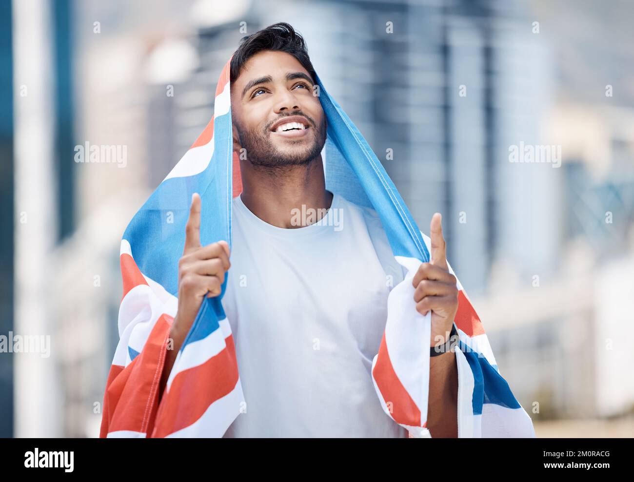 One male runner looking and pointing up at the sky thanking God and ...