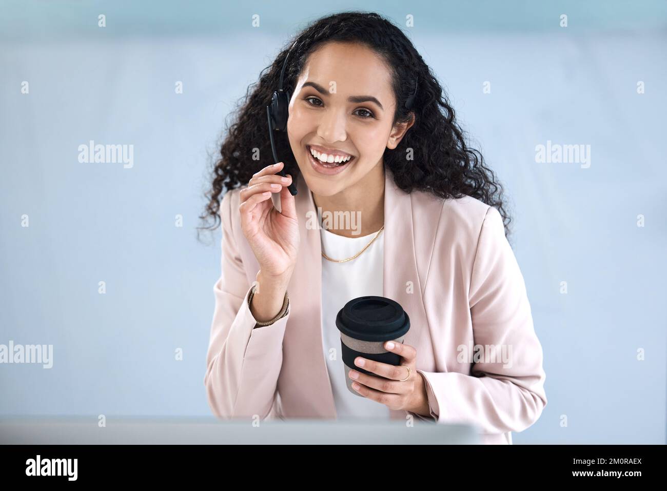Young mixed race female call center agent using a desktop computer ...