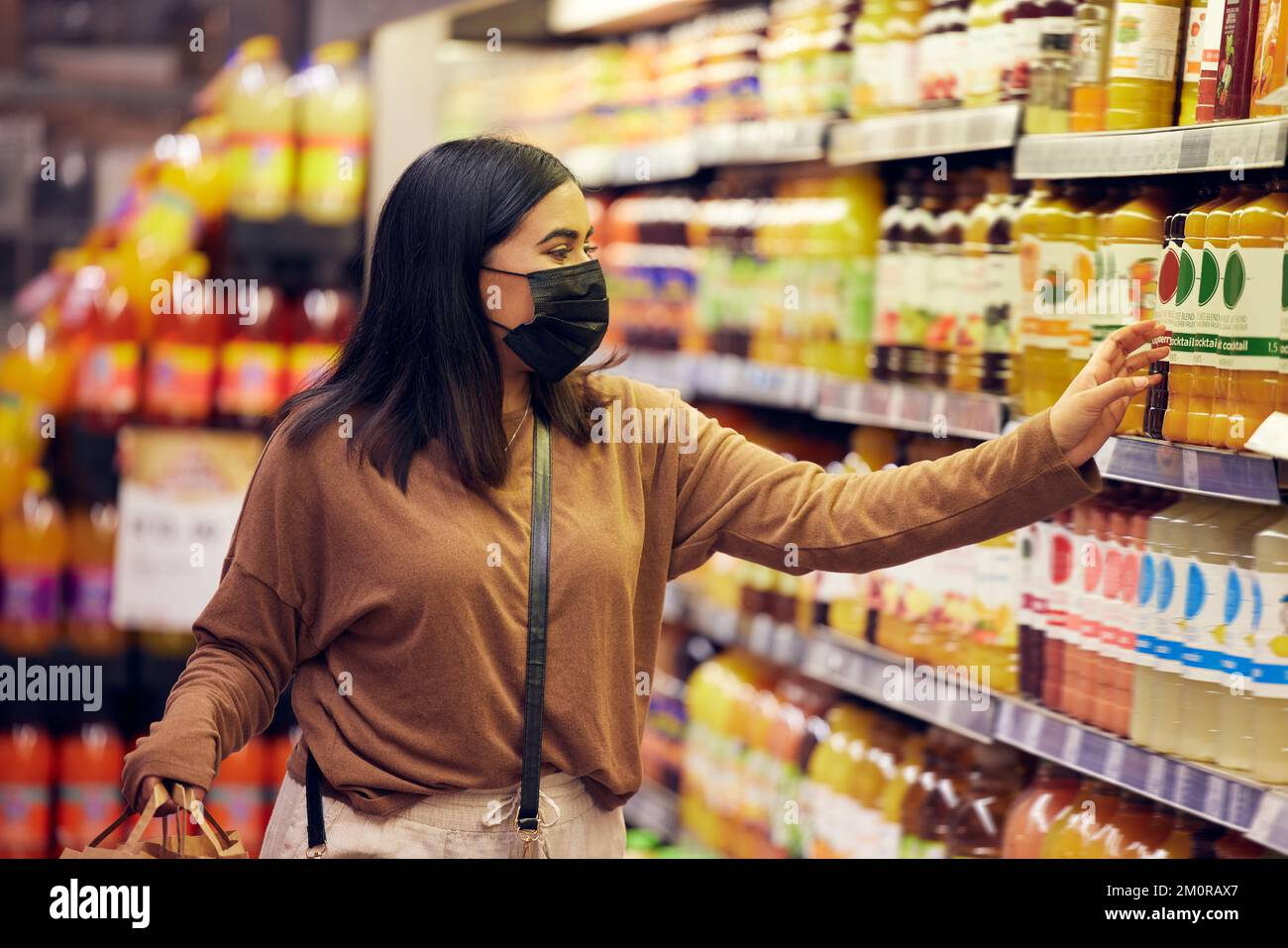 Time for the weekly grocery shop. a young woman doing her weekly ...