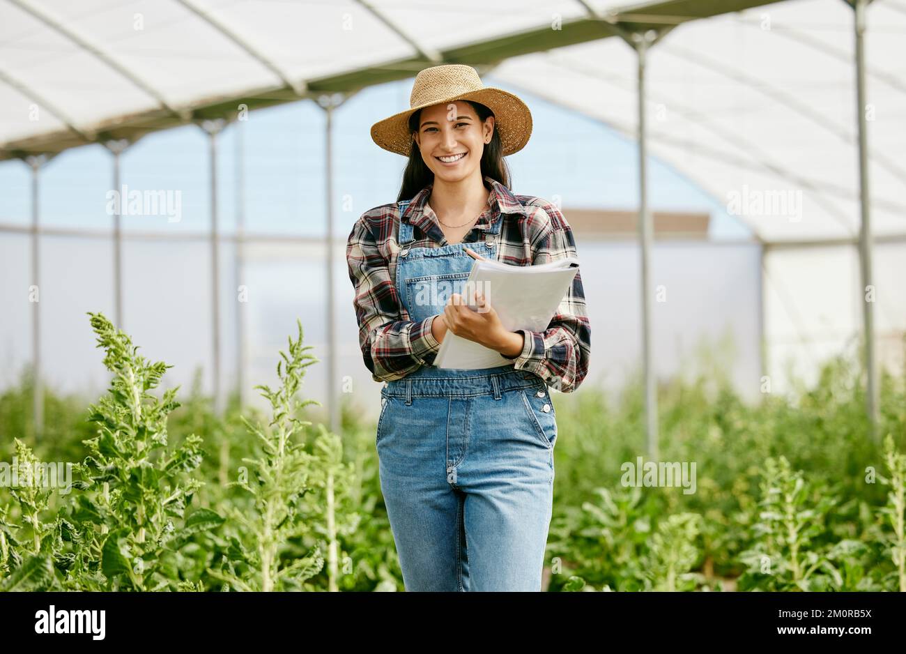 So happy with how far Ive come. a young female farmer taking note of ...