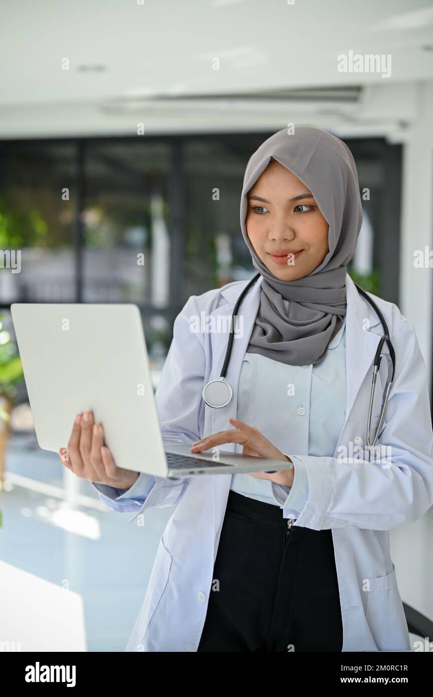 Portrait, Beautiful and professional young Asian Muslim female doctor ...