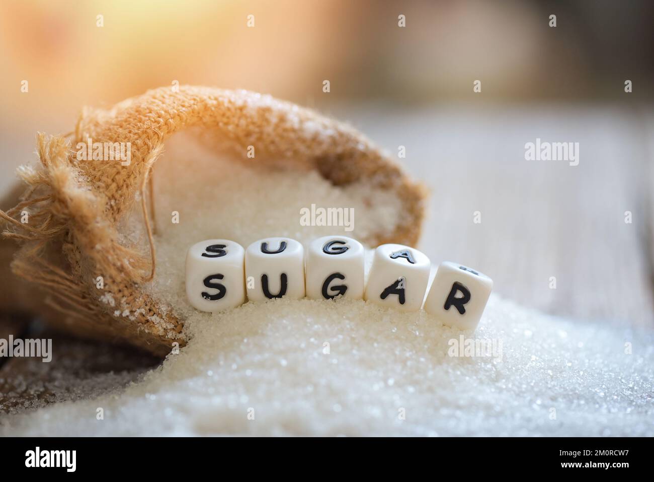 Sugar on sack and wooden background, white sugar for food and sweets ...