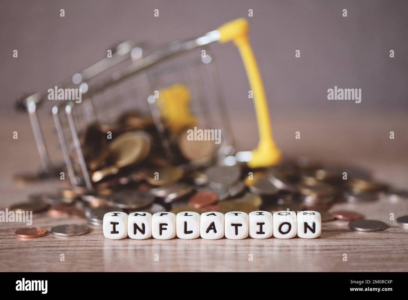 inflation with coin and shopping cart on wooden background, business ...
