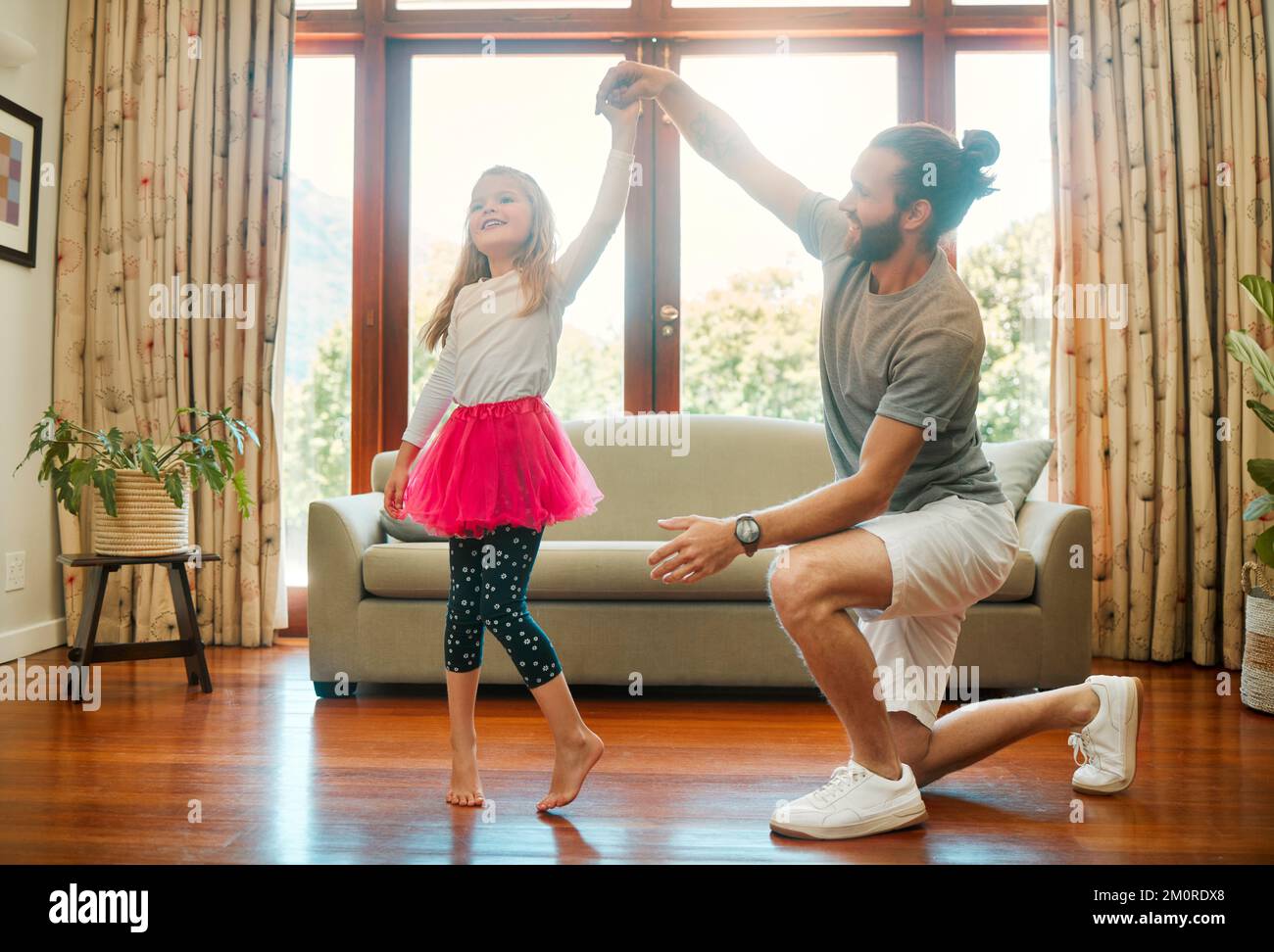 Young happy caucasian father and daughter dancing together in the ...