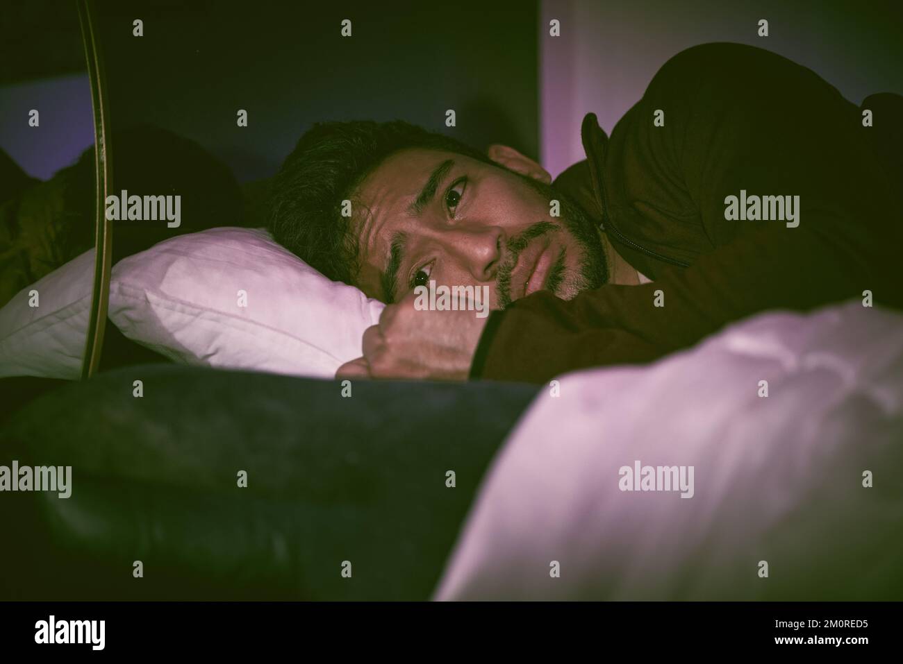 Asian man with mental disorder lying alone at night and feeling ...