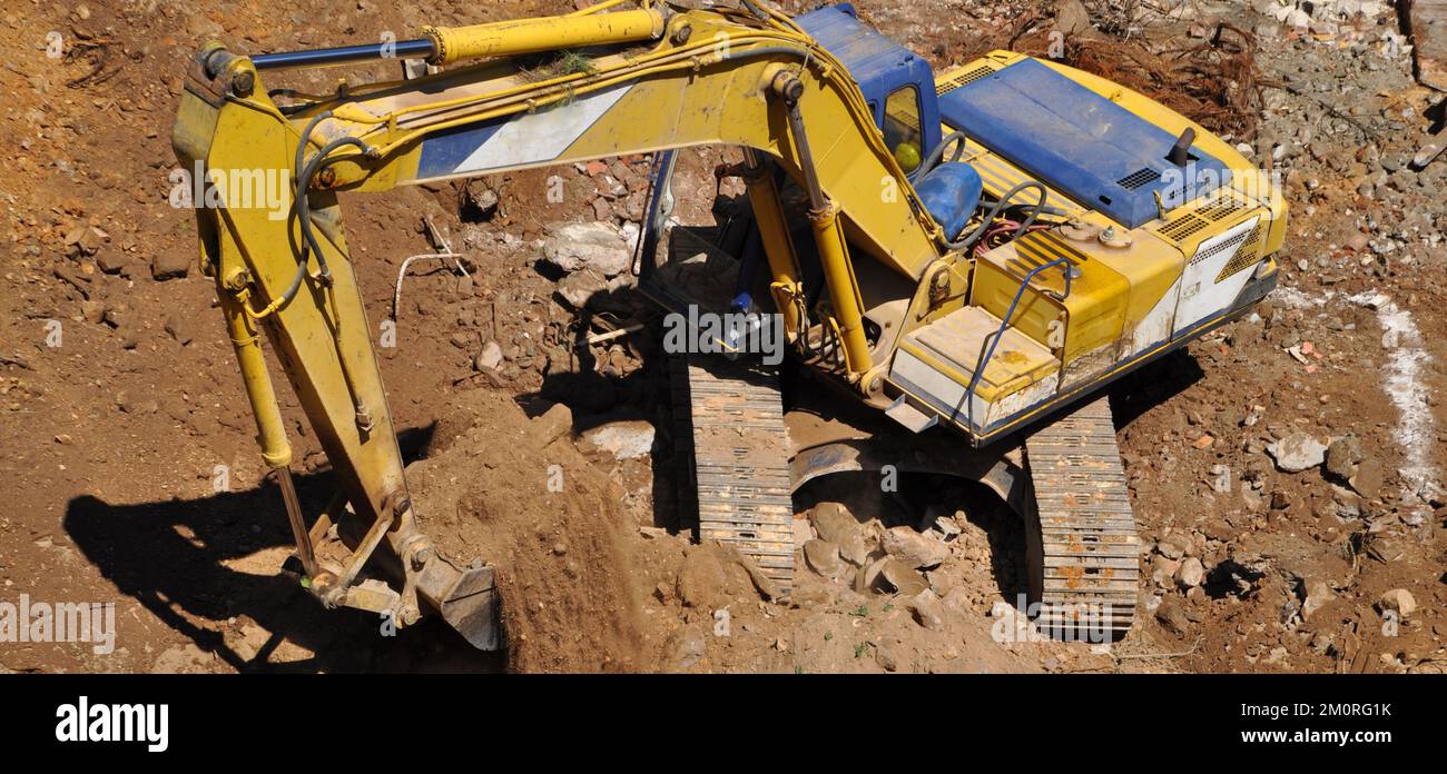 Excavator continues to work at the construction site, excavation site ...