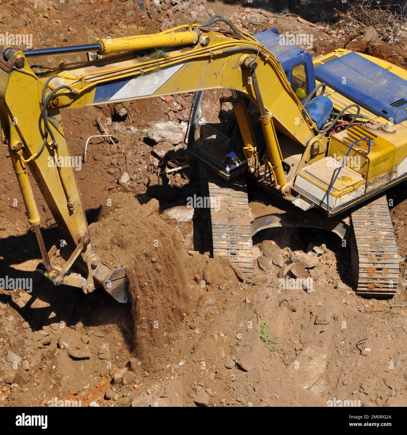 Excavator continues to work at the construction site, excavation site ...