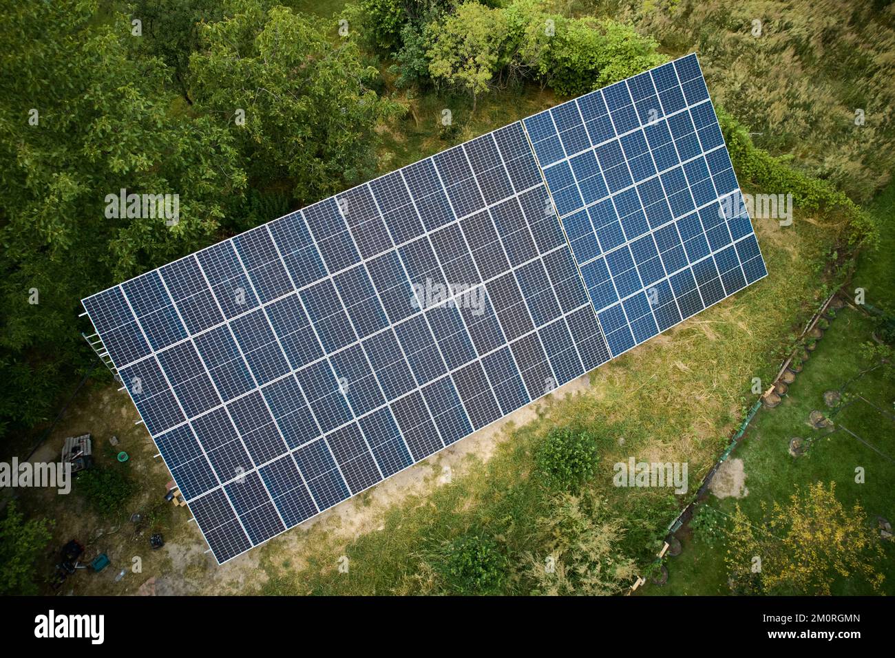 Aerial view of solar panels in green field at daytime. Different types ...
