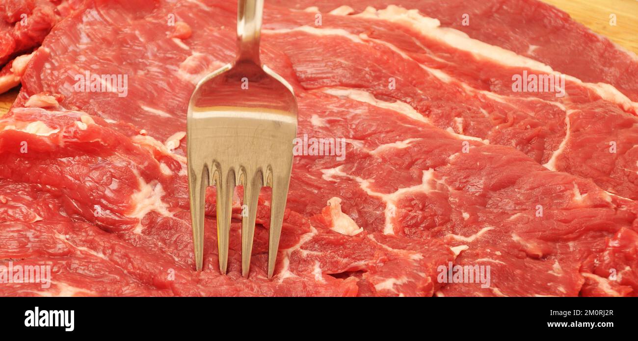 Clean very fresh red raw cow meat beef and fork, bamboo on cutting ...