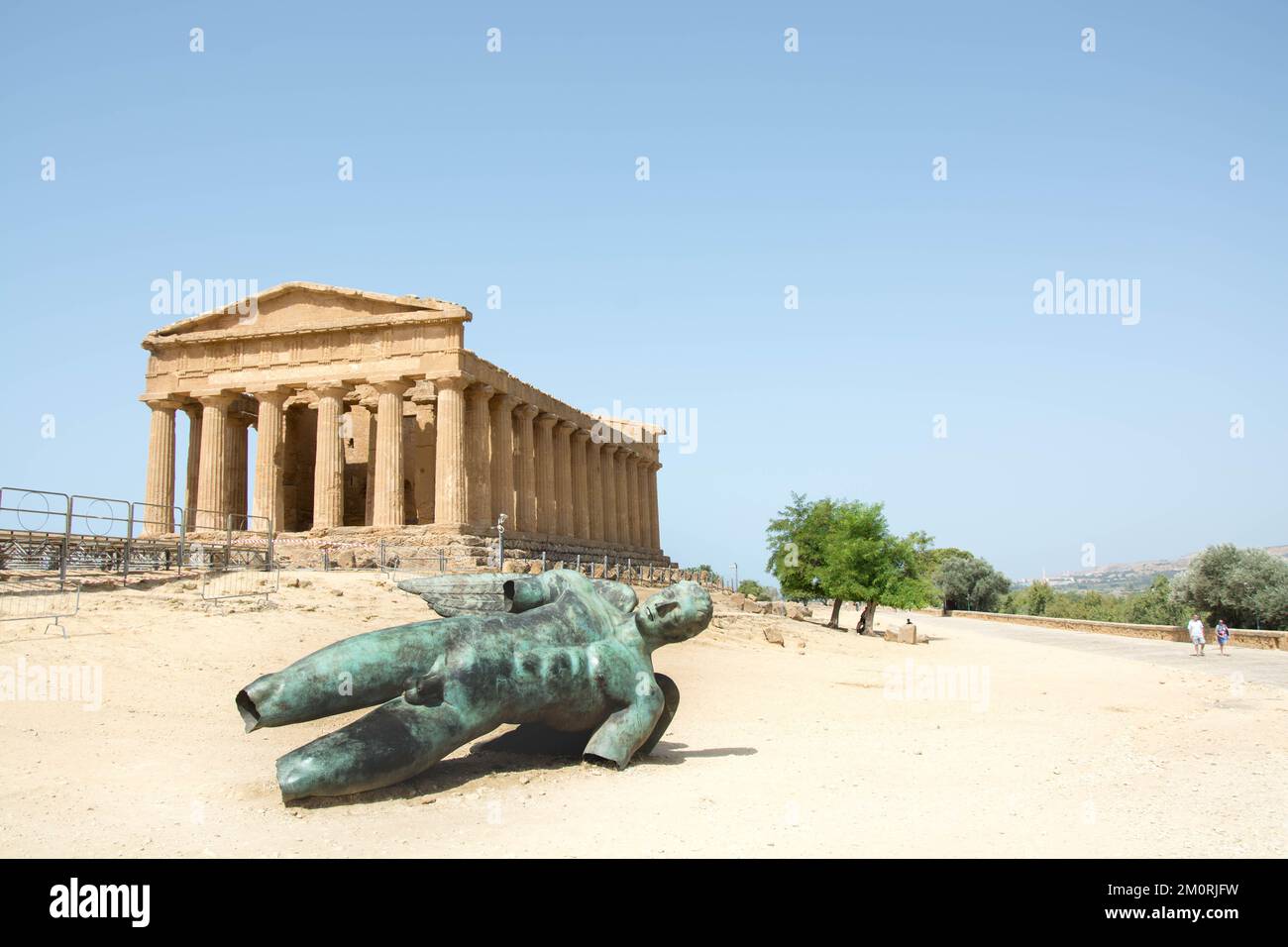 A fallen angel statue in background of old stony building in Agrigento ...