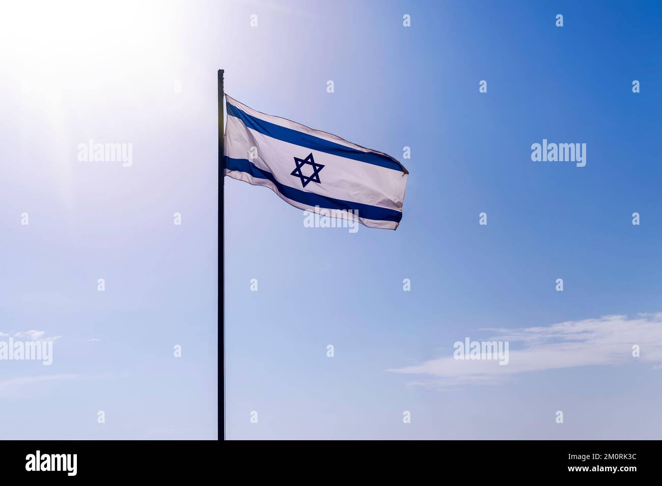 Israel flag flapping in the wind at good sunny day and old city ...