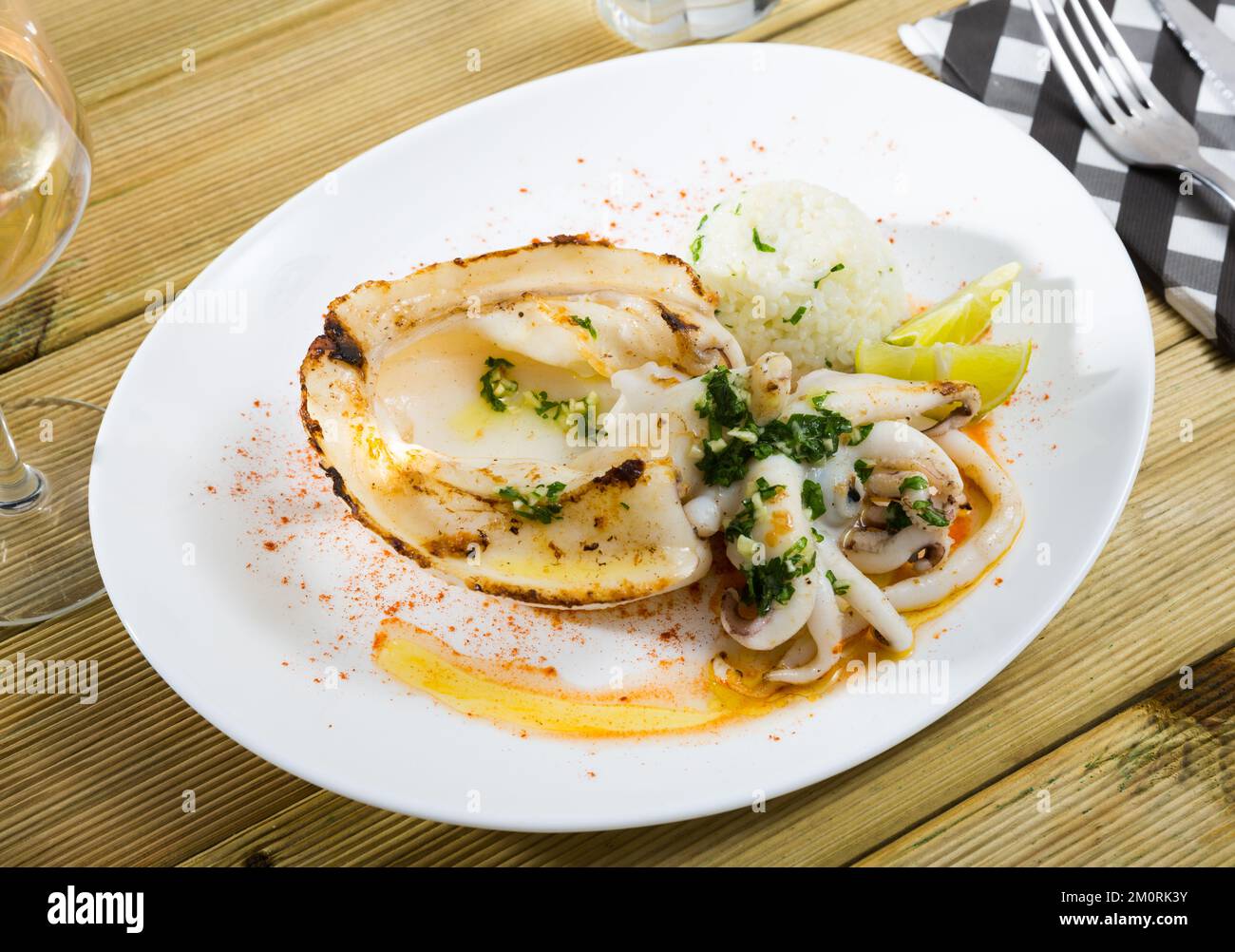Baked in oven cuttlefish, rice, lemon Stock Photo - Alamy