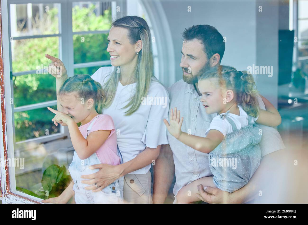 Do you see what I see. a young family looking out of their window from ...