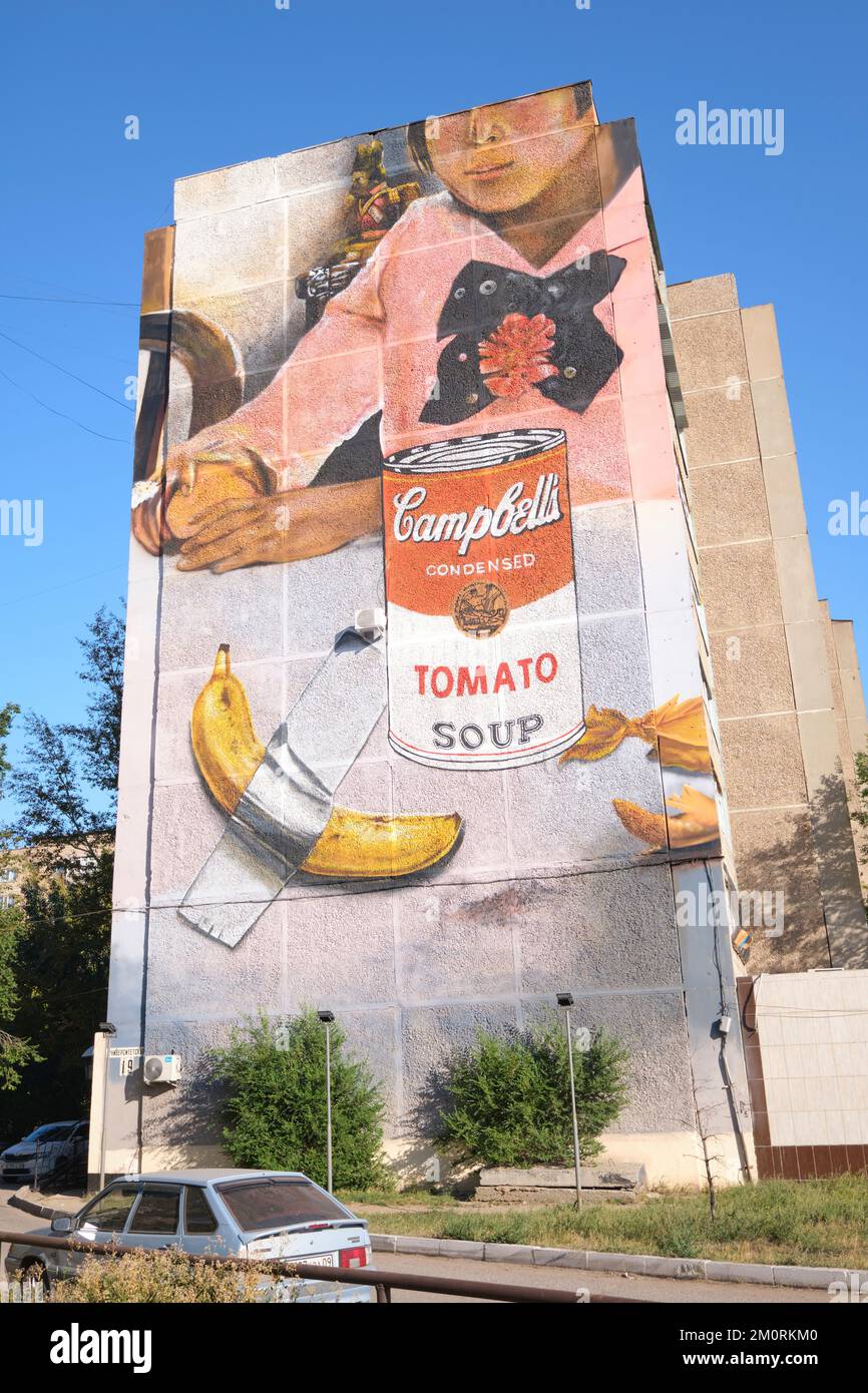 A giant painted mural on the end of a large apartment building ...