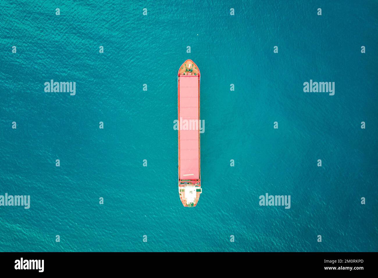 Red color container ship at sea shot from above. Scenic waterscape and ...