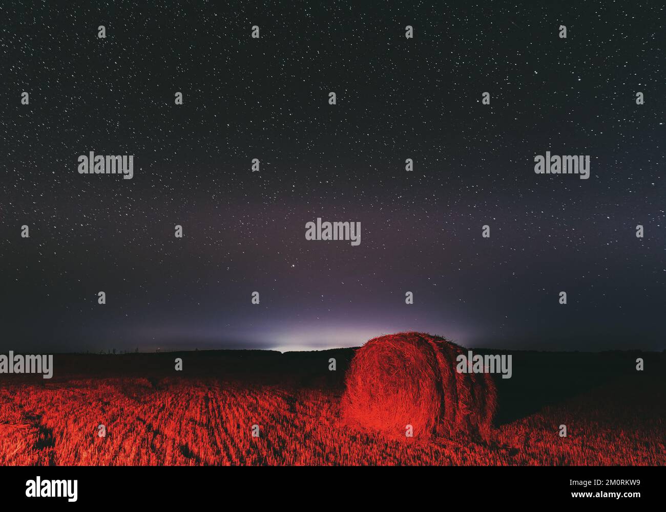 Glowing Stars And Sunset Lights Hay Bales After Harvest. Agricultural ...