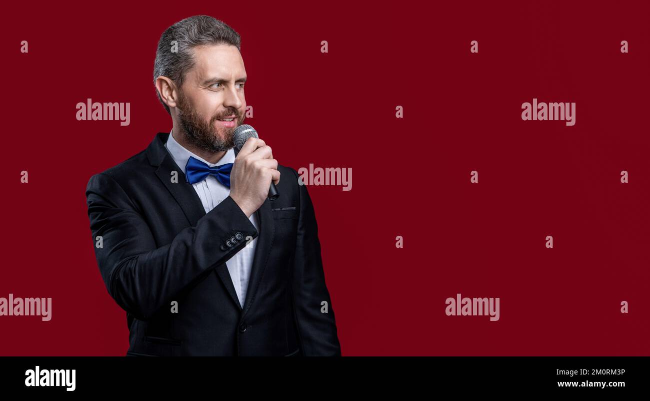 photo of man presenter in tuxedo hold microphone, copy space. tuxedo ...