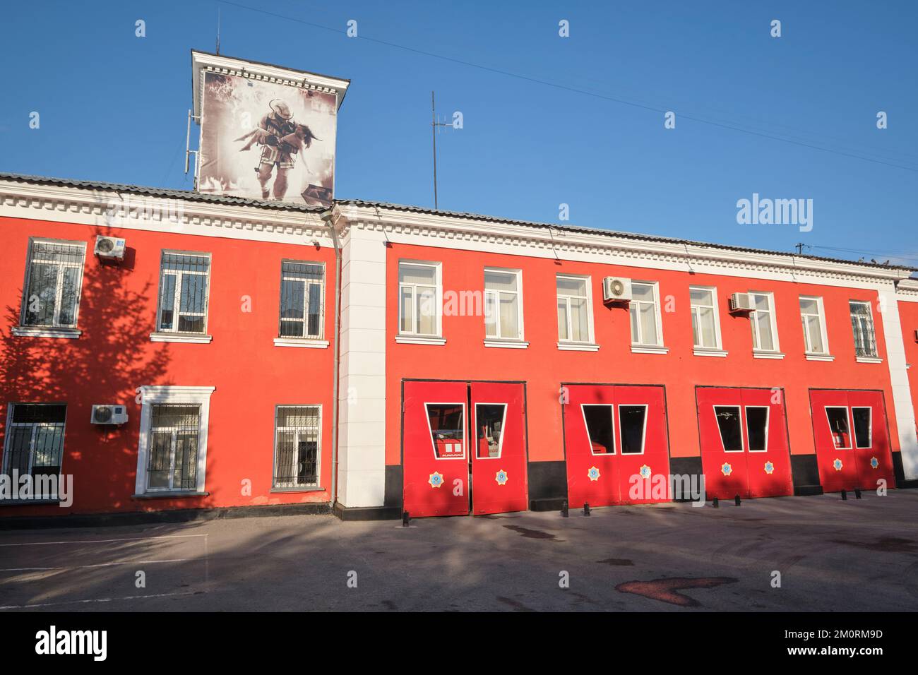 A typical, red fire station with a large photograph of a resue on its ...