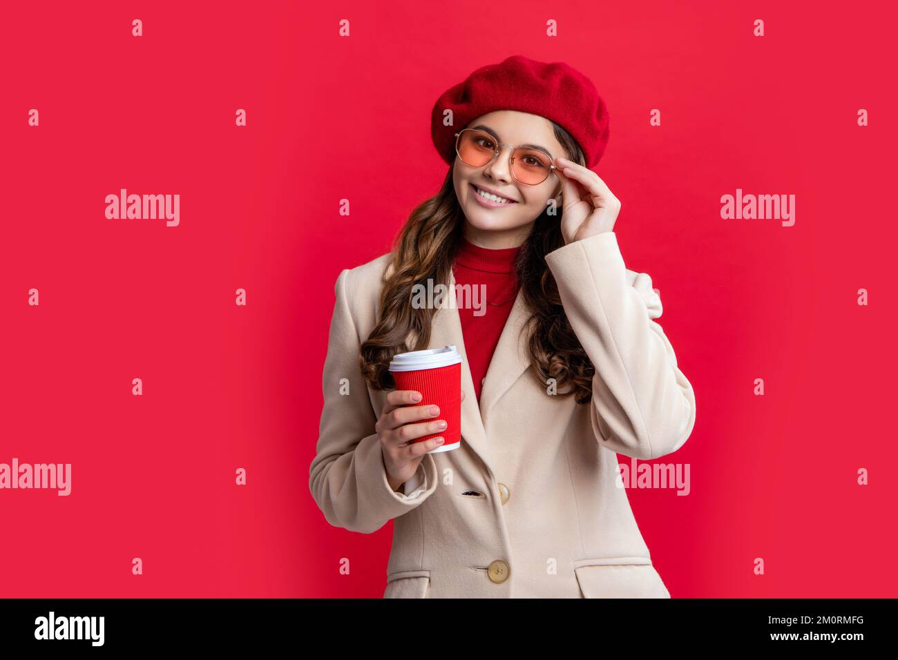 stylish teen girl holding coffee in studio. young stylish teen girl ...