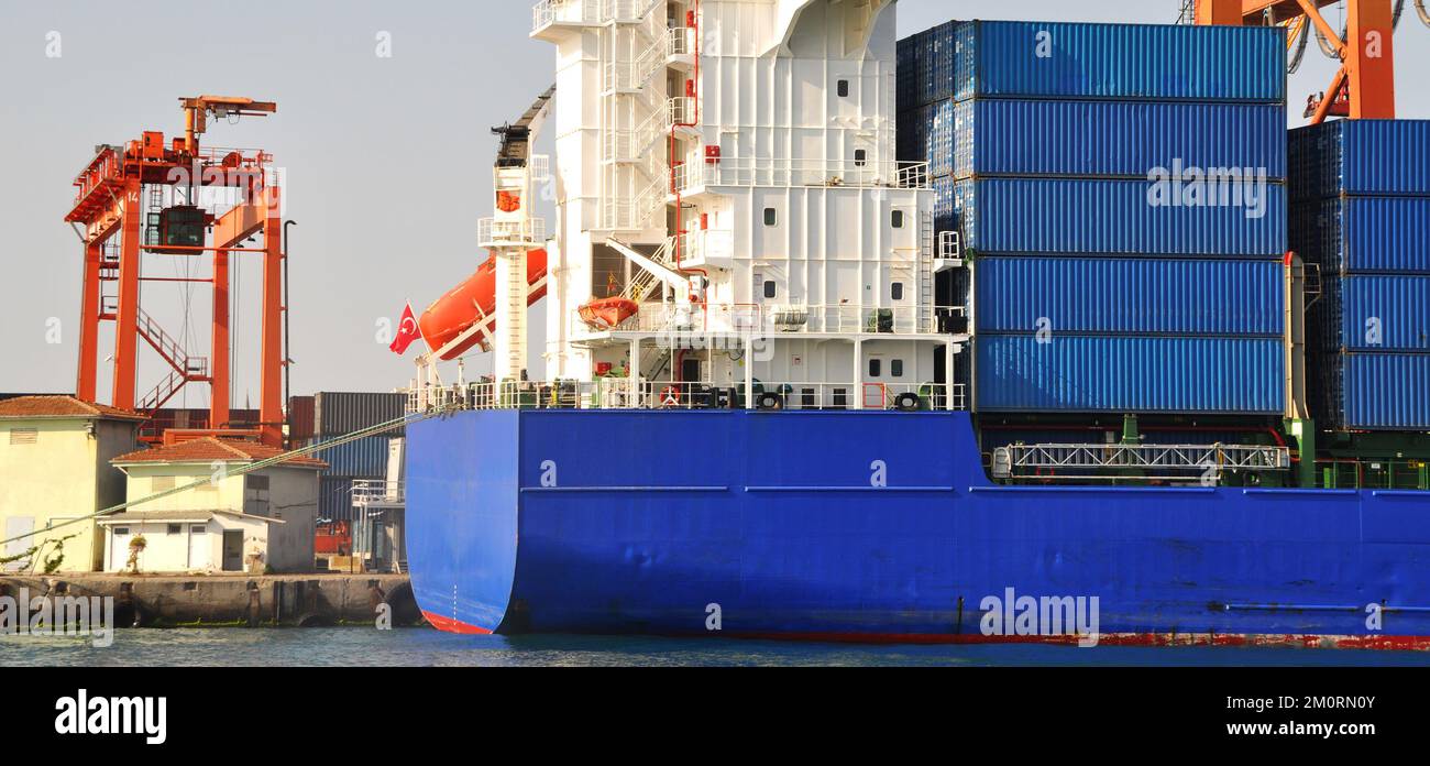 Blue colored cargo ship engaged in international logistics ...