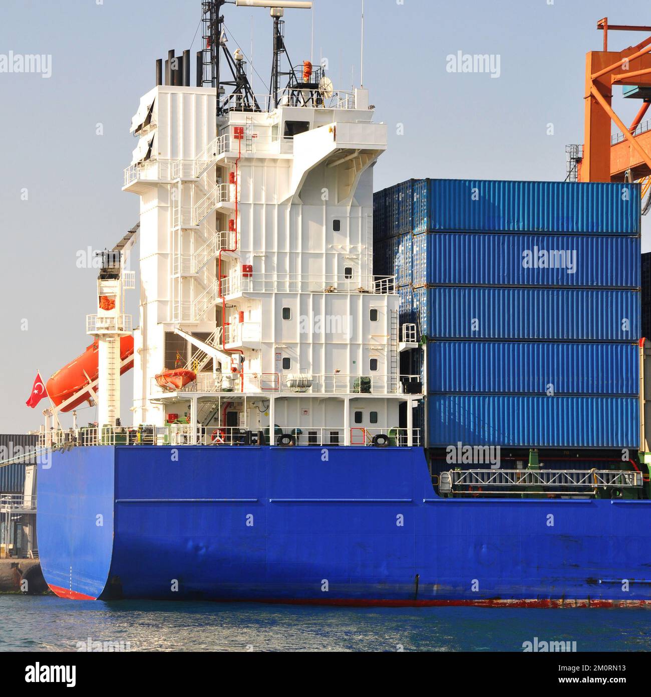 Blue colored cargo ship engaged in international logistics ...