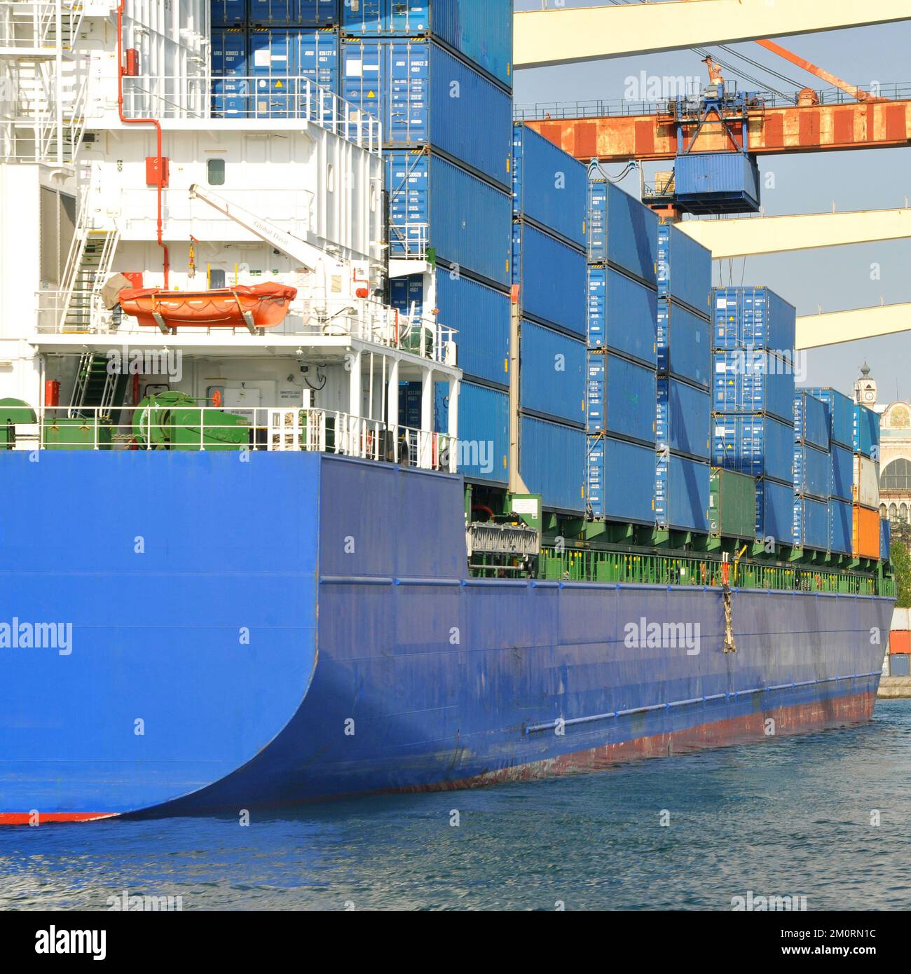 Blue colored cargo ship engaged in international logistics ...