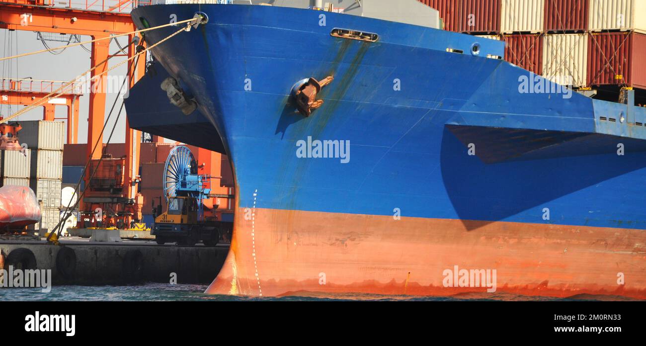 Blue colored cargo ship engaged in international logistics ...