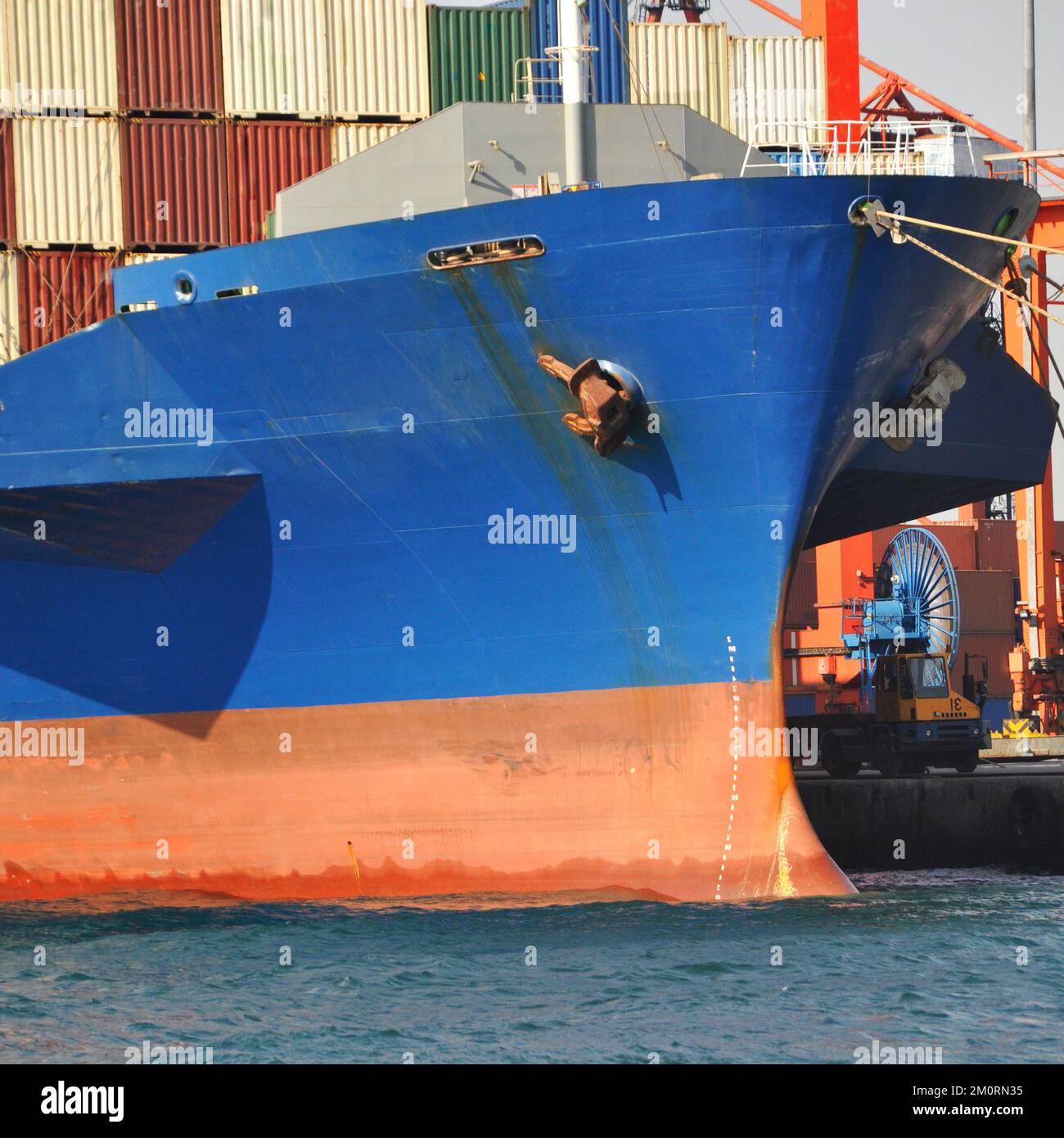Blue colored cargo ship engaged in international logistics ...