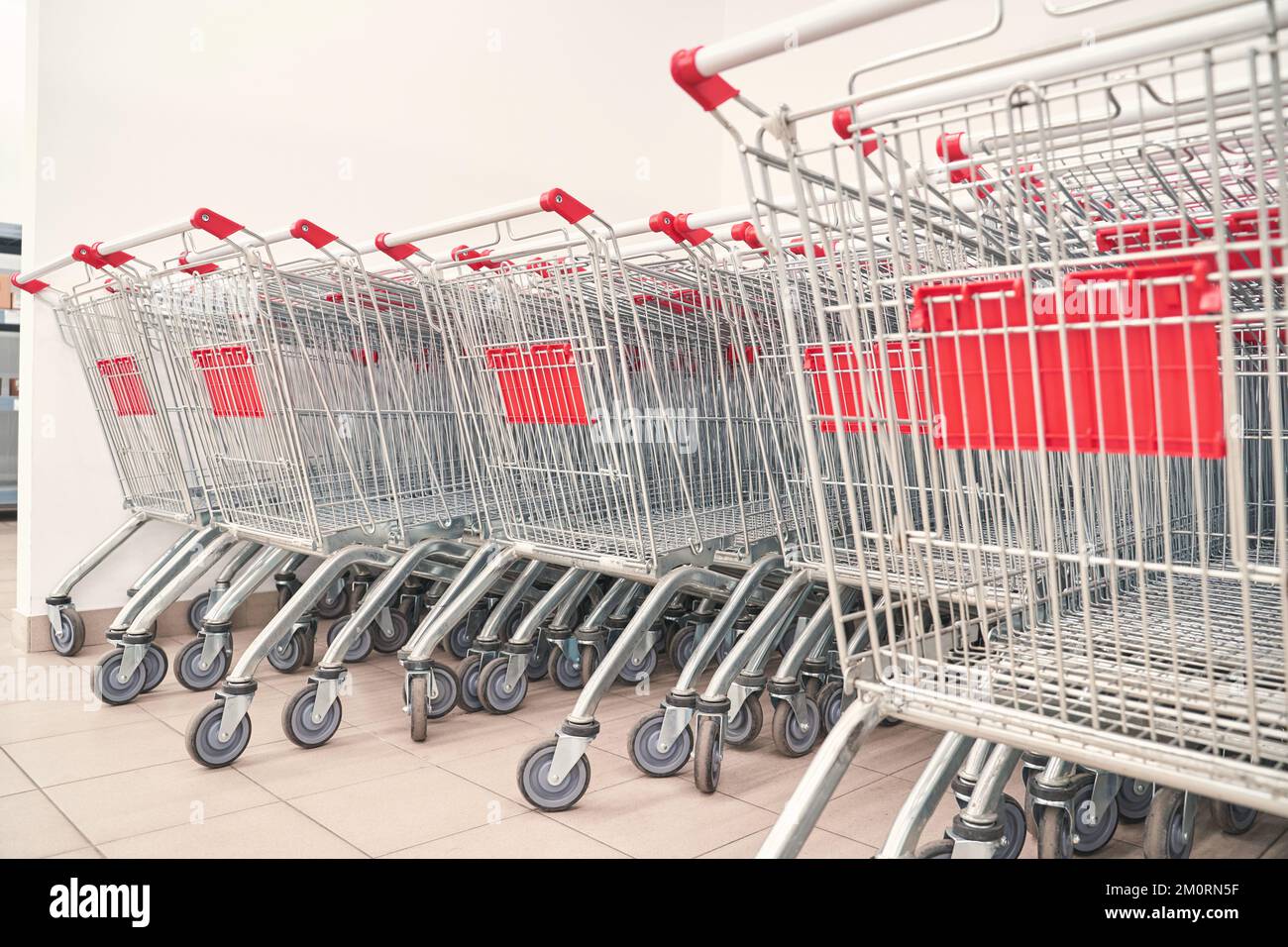 Many same shop trolley. Retail consumer carts. Empty parking store mall ...