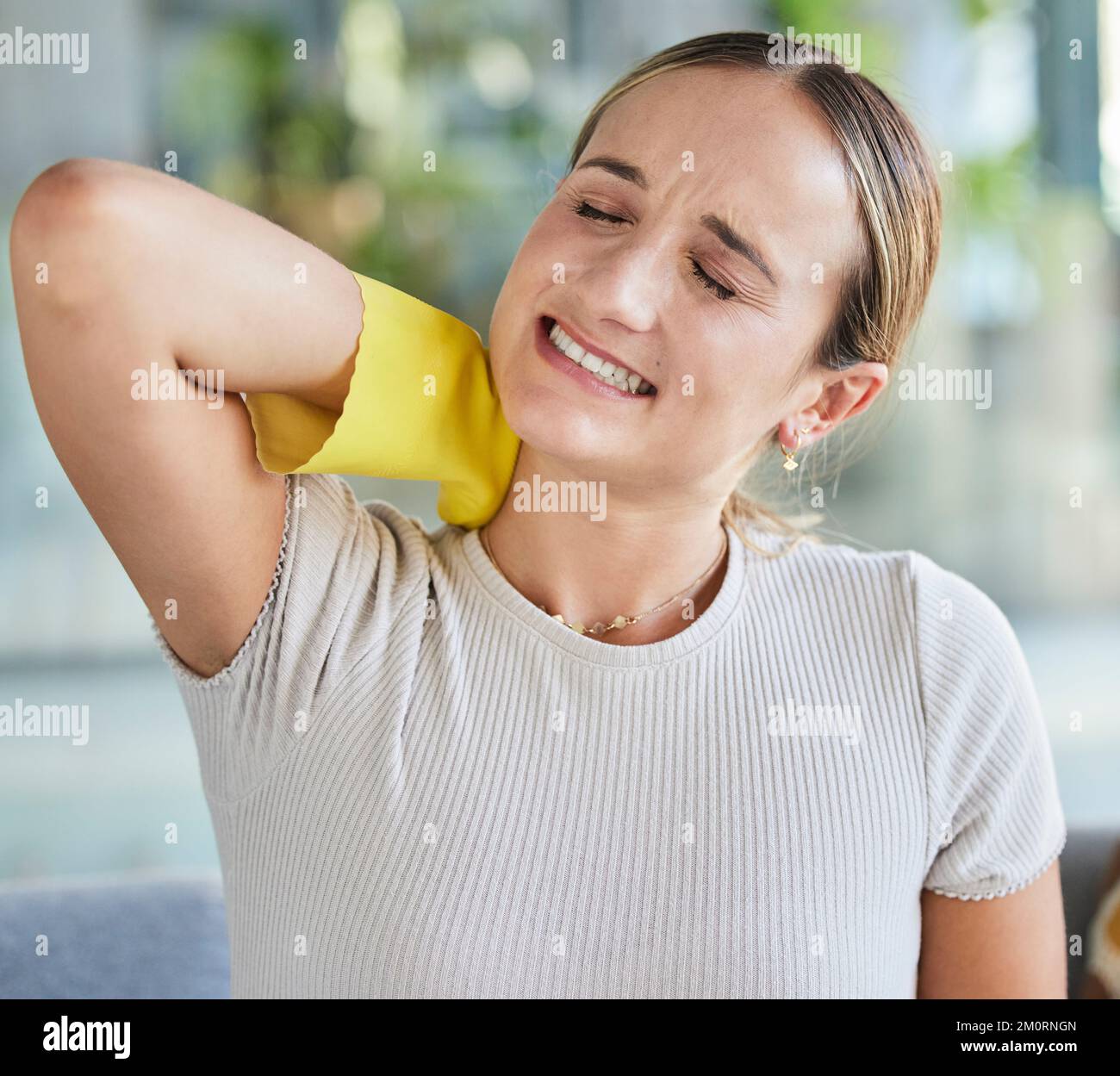 Cleaning, housekeeping and woman with neck pain tired with rubber ...