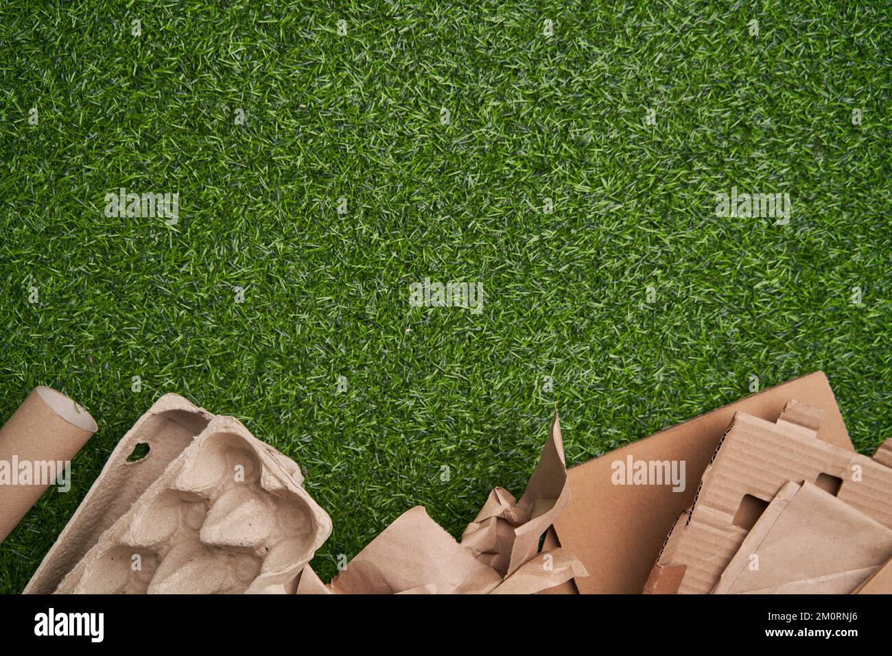 Paper collected for recycling on green grass background. Concept of ...