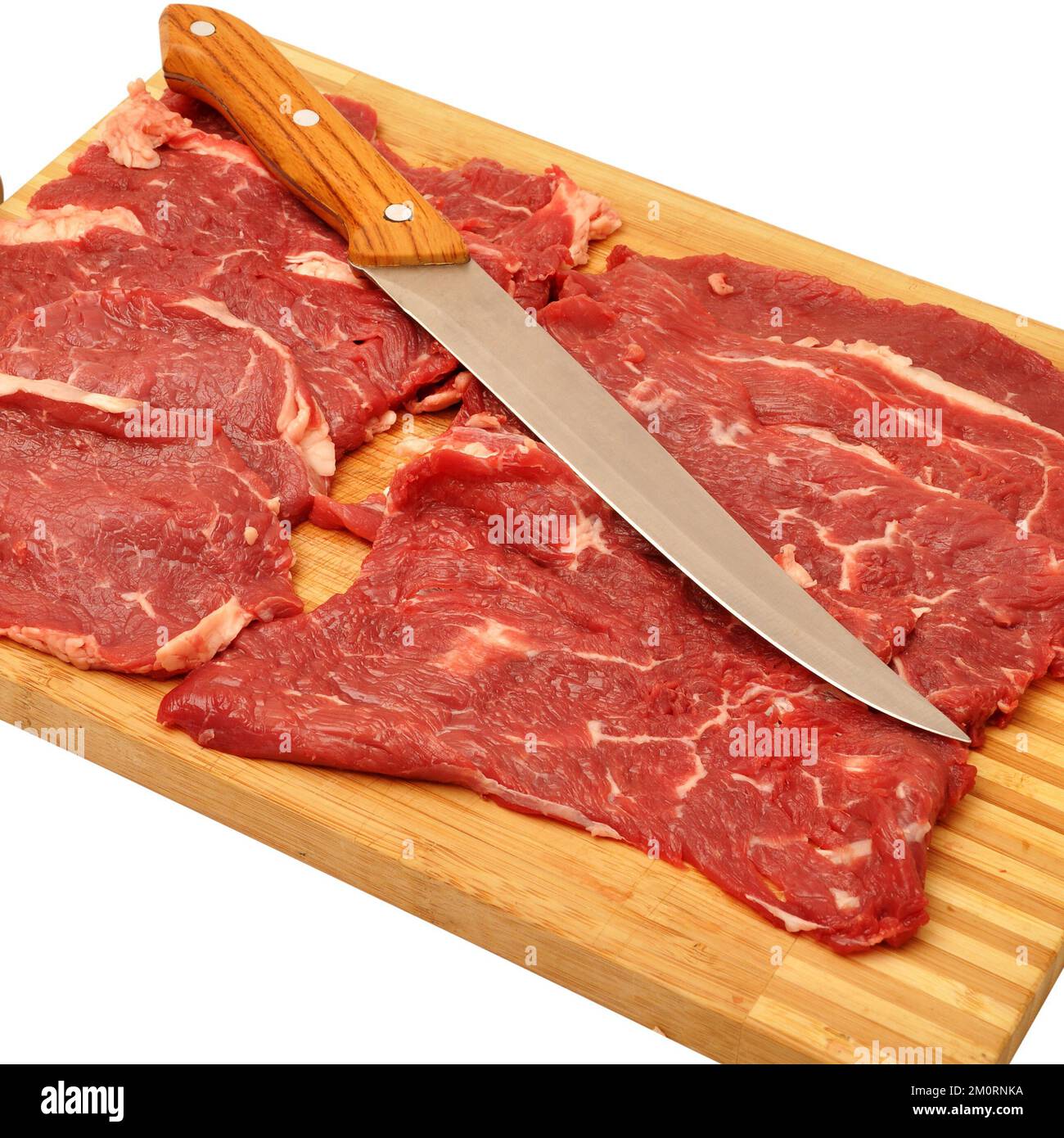 Clean very fresh red raw cow meat and a sharp knife, on cutting board ...