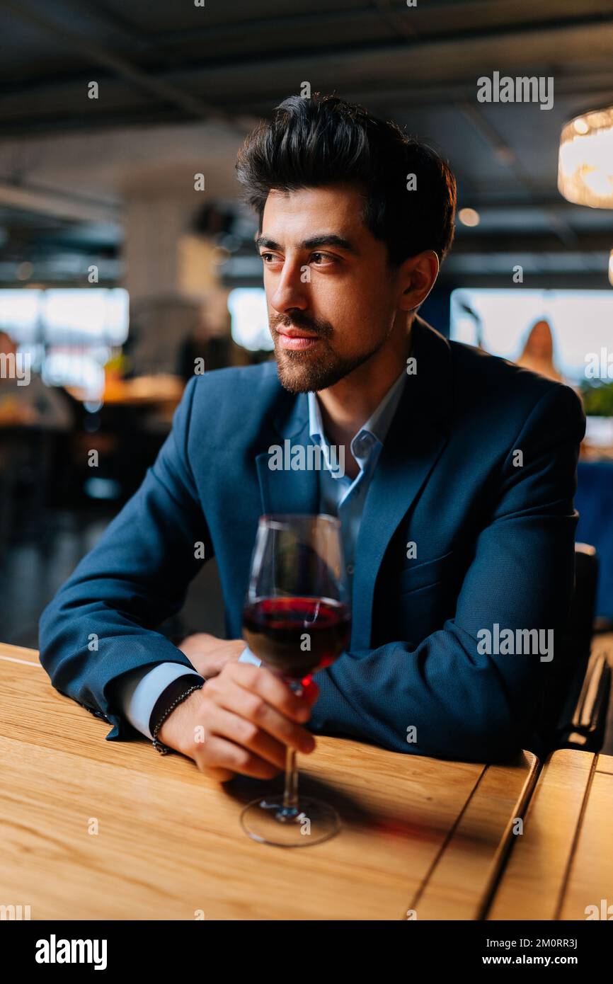 Vertical portrait of successful elegant man in fashion suit holding ...