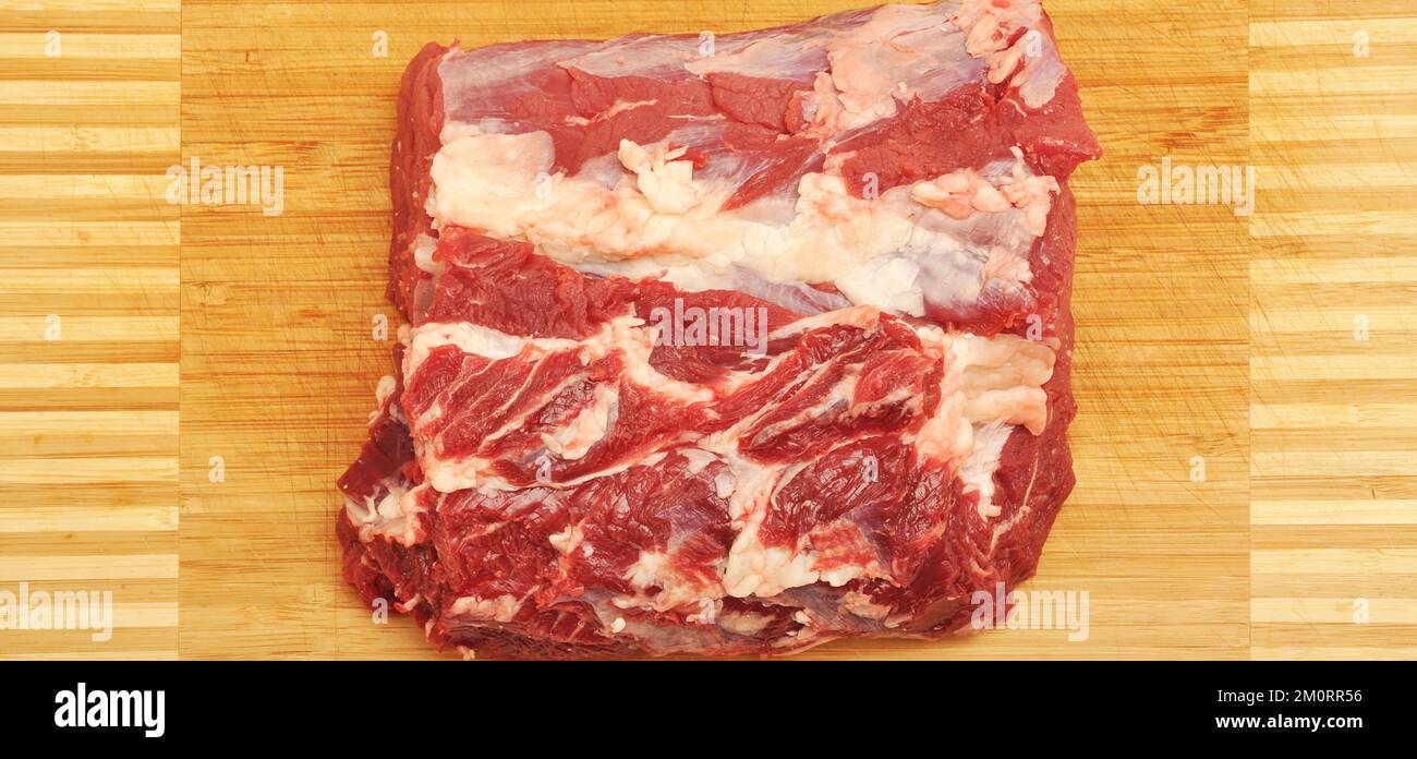 Clean very fresh red raw cow meat beef, bamboo on cutting board, cow ...