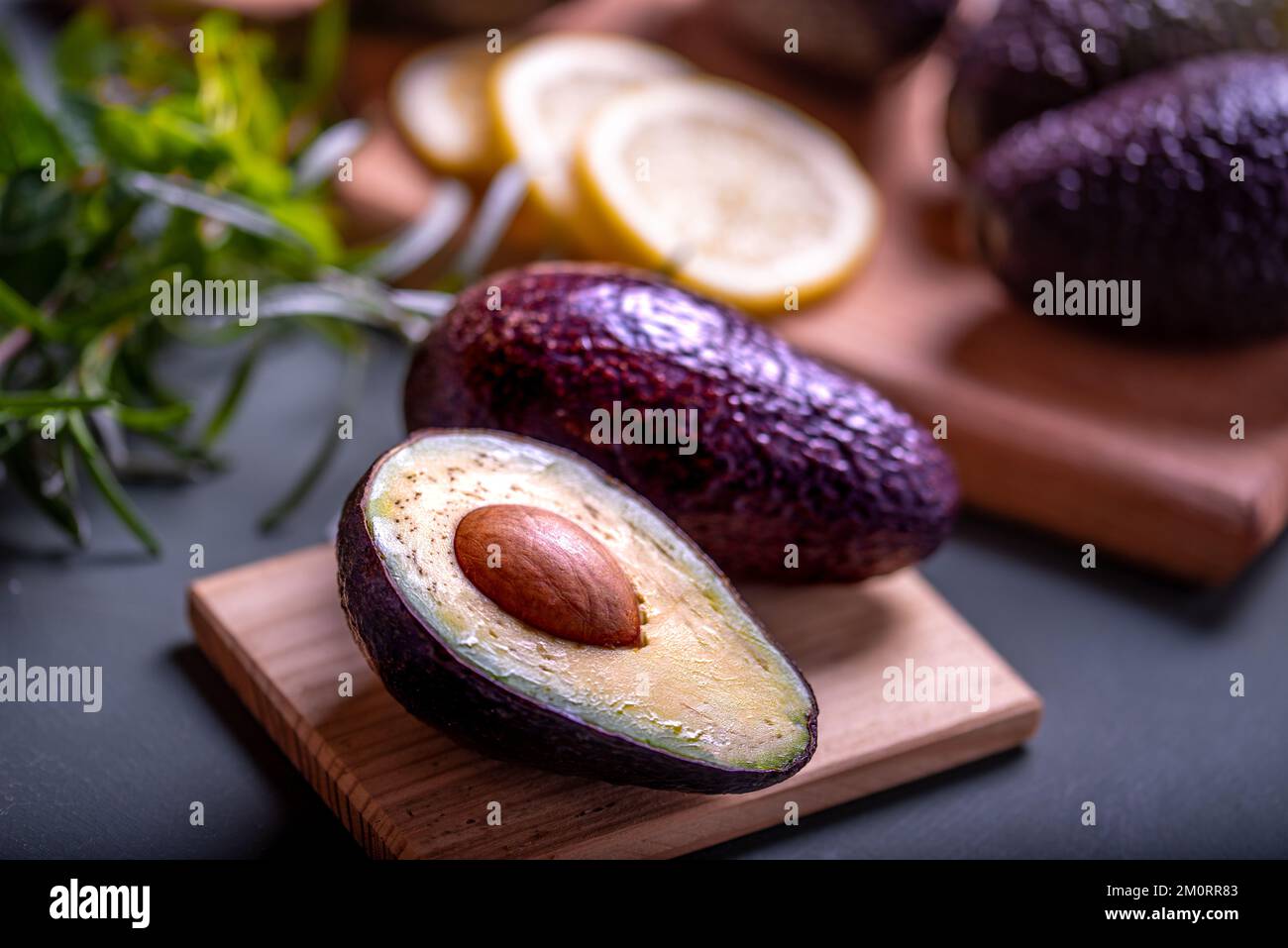 Fresh avocado, citrus slices and rosemary on the cutting board. Avocado ...
