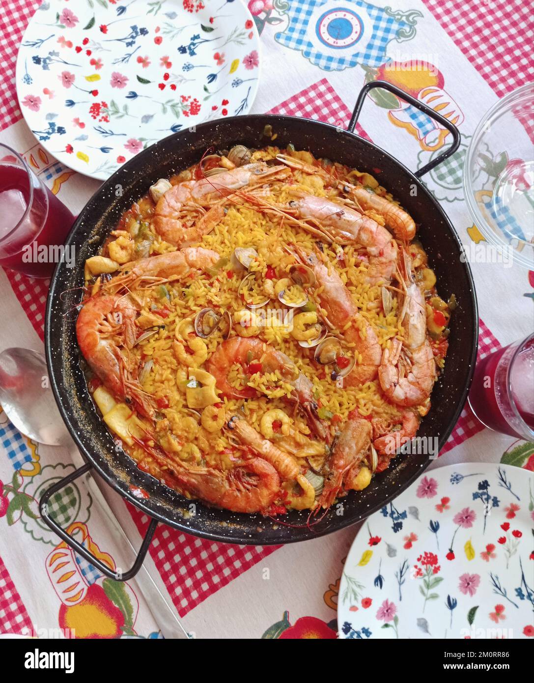 Overhead view of a traditional Spanish paella on a table with sangria ...