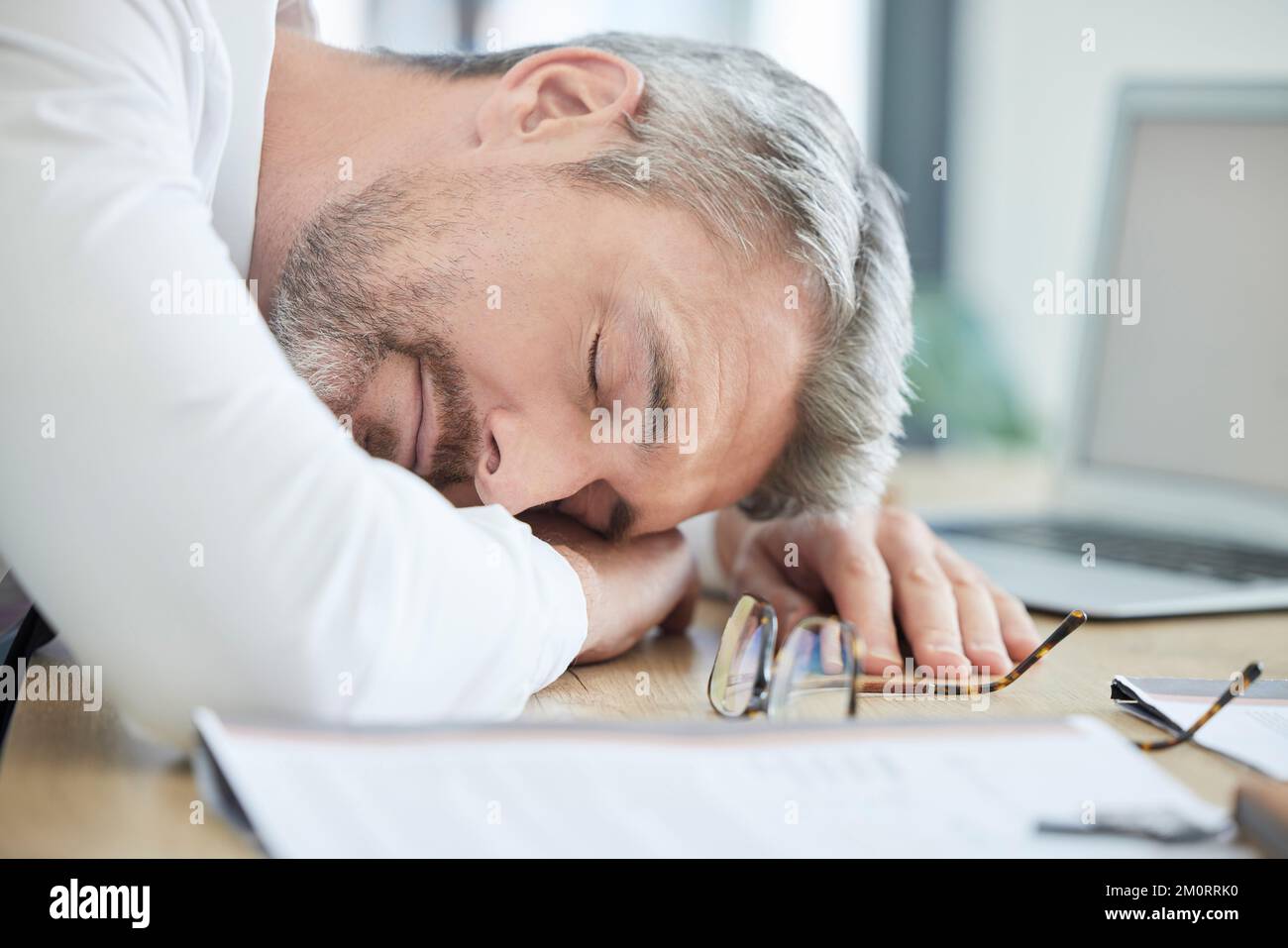 Burnout, sleeping and tired business man at his desk for financial ...