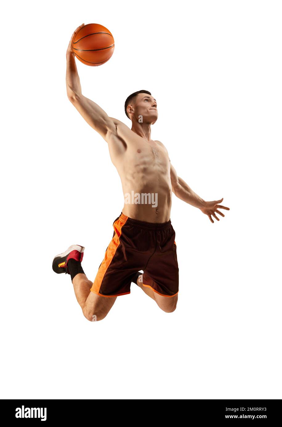 Slam dunk. Young muscled man, basketball player training with ...