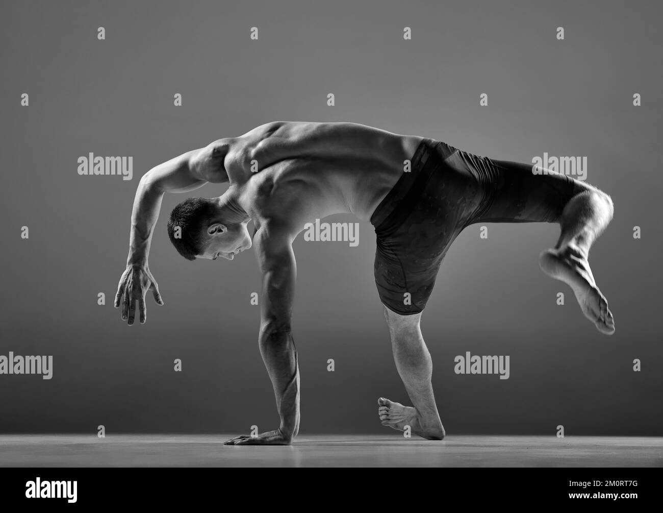 Black and white footage of male flexible muscular athlete showing ...