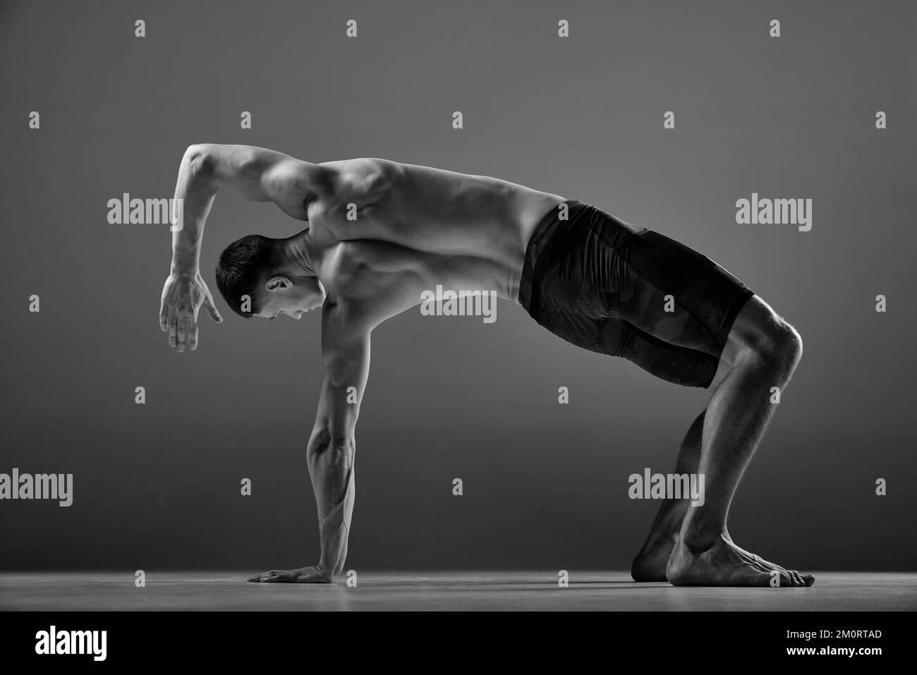 Black and white footage of male flexible muscular athlete showing ...