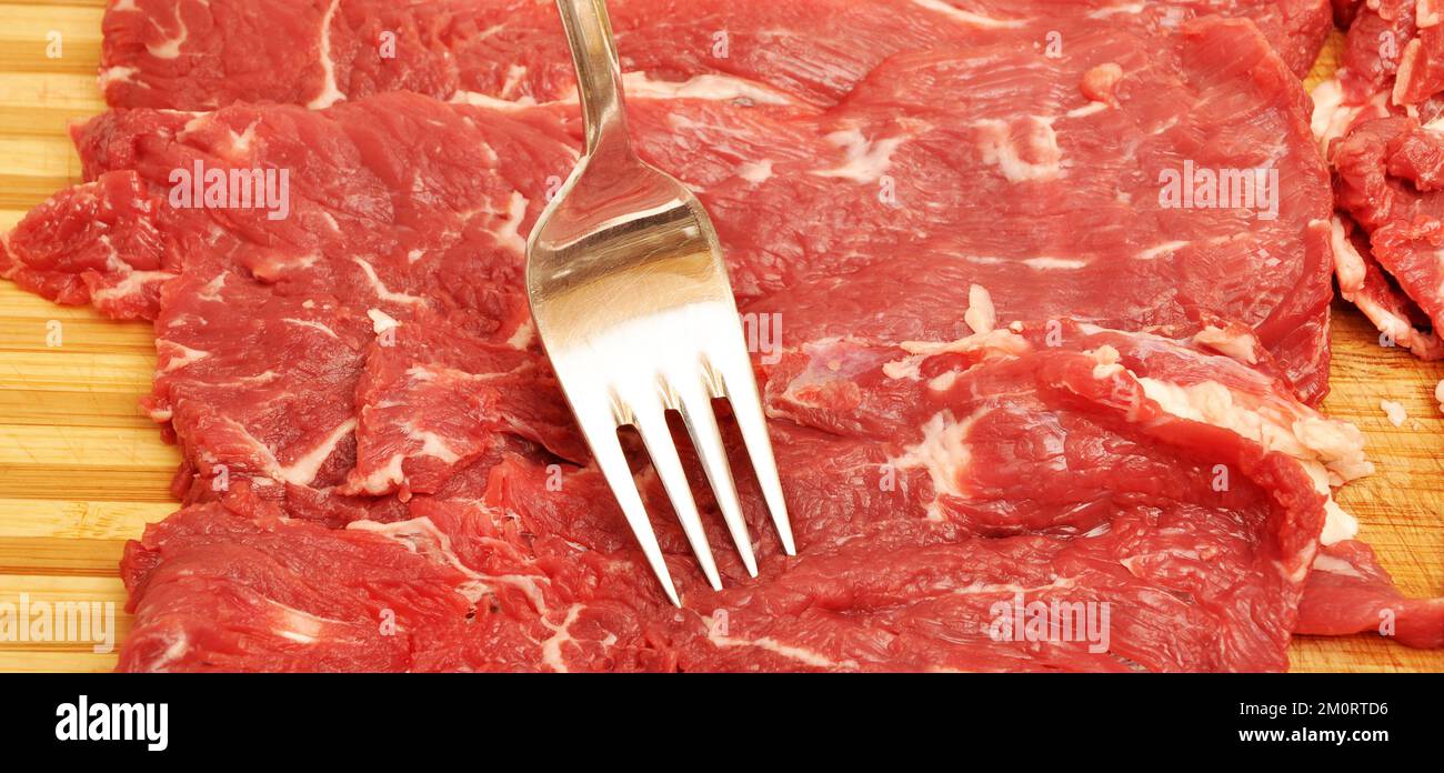 Clean very fresh red raw cow meat beef and fork, bamboo on cutting ...