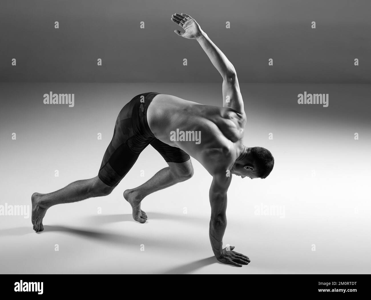 Black and white footage of male flexible muscular athlete showing ...