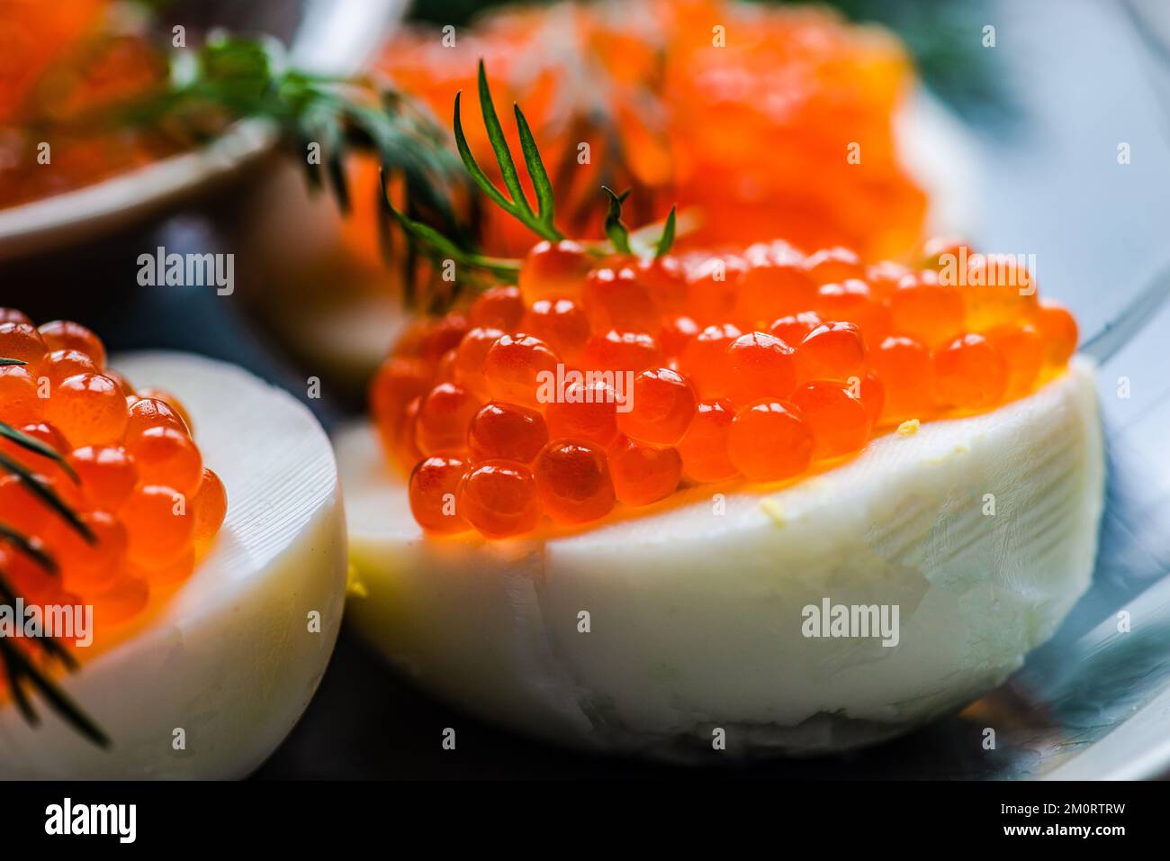 Close-up hard boiled eggs with red trout caviar Stock Photo - Alamy